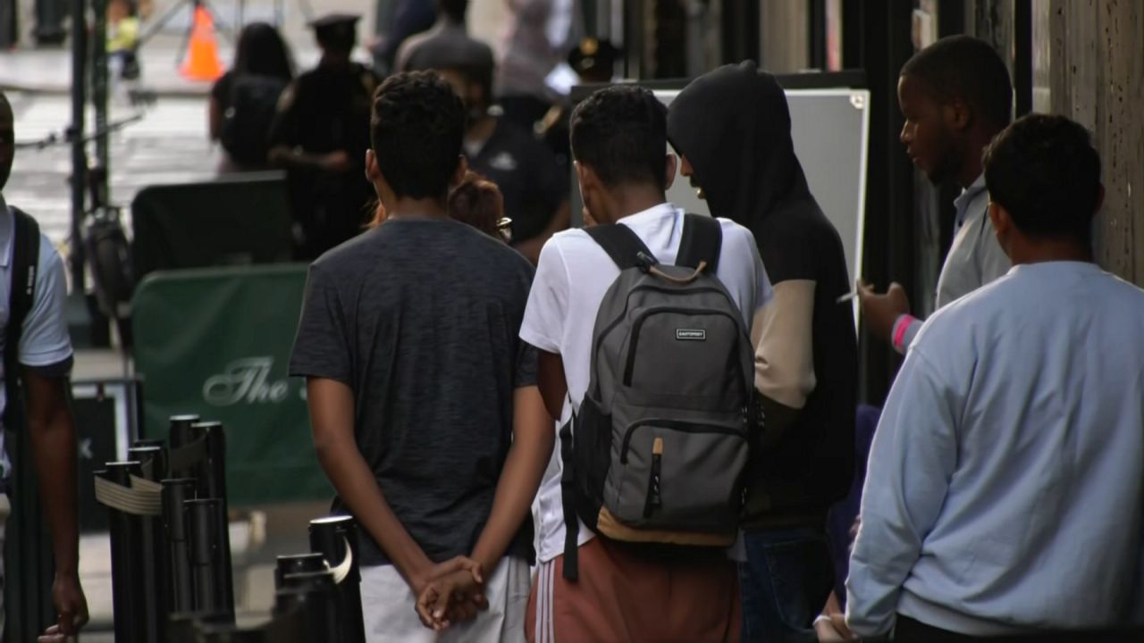 With hotels at capacity, dozens of migrants sleep outside