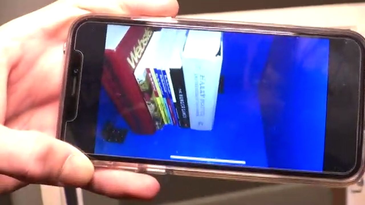 Eighth Graders Build Little Free Library with Camera