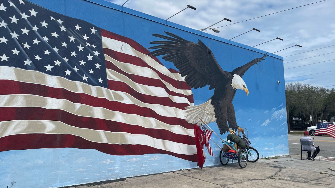 Homeless vet waves the American flag to get off the streets