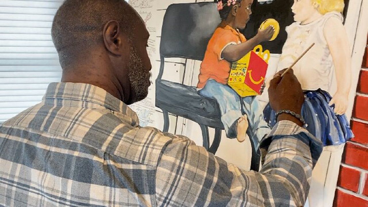 Local artist painting for his community