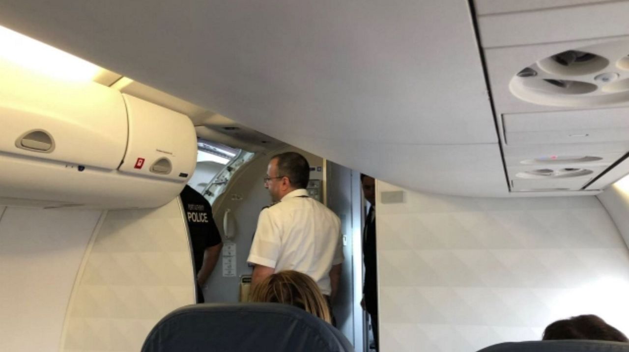 Witness: Woman Aboard Flight From RDU Tried to Jump from Plane
