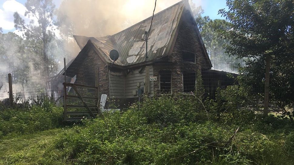 Crews battle two-story house fire in Mims