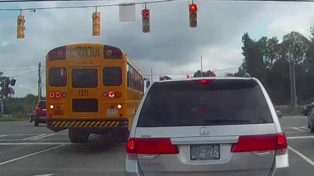 Video shows school bus crossing intersection at red light
