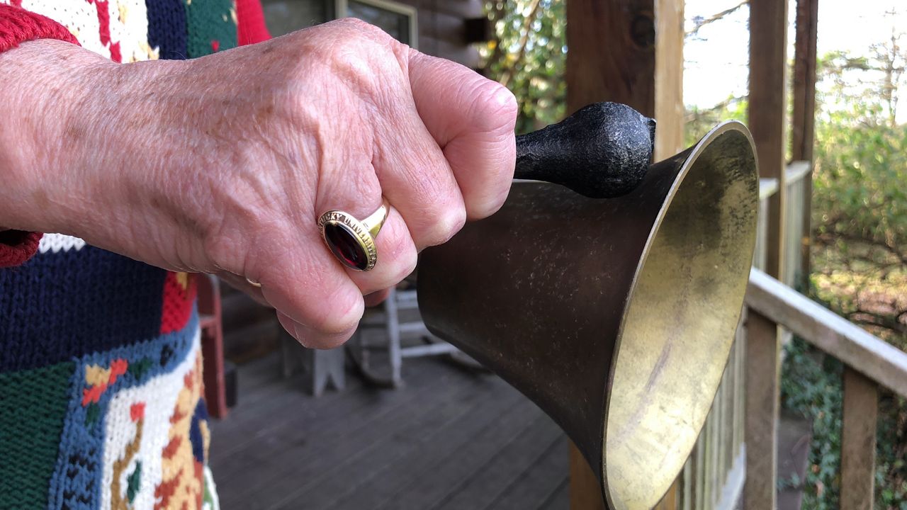 Woman ringing her bell to honor COVID-19 victims