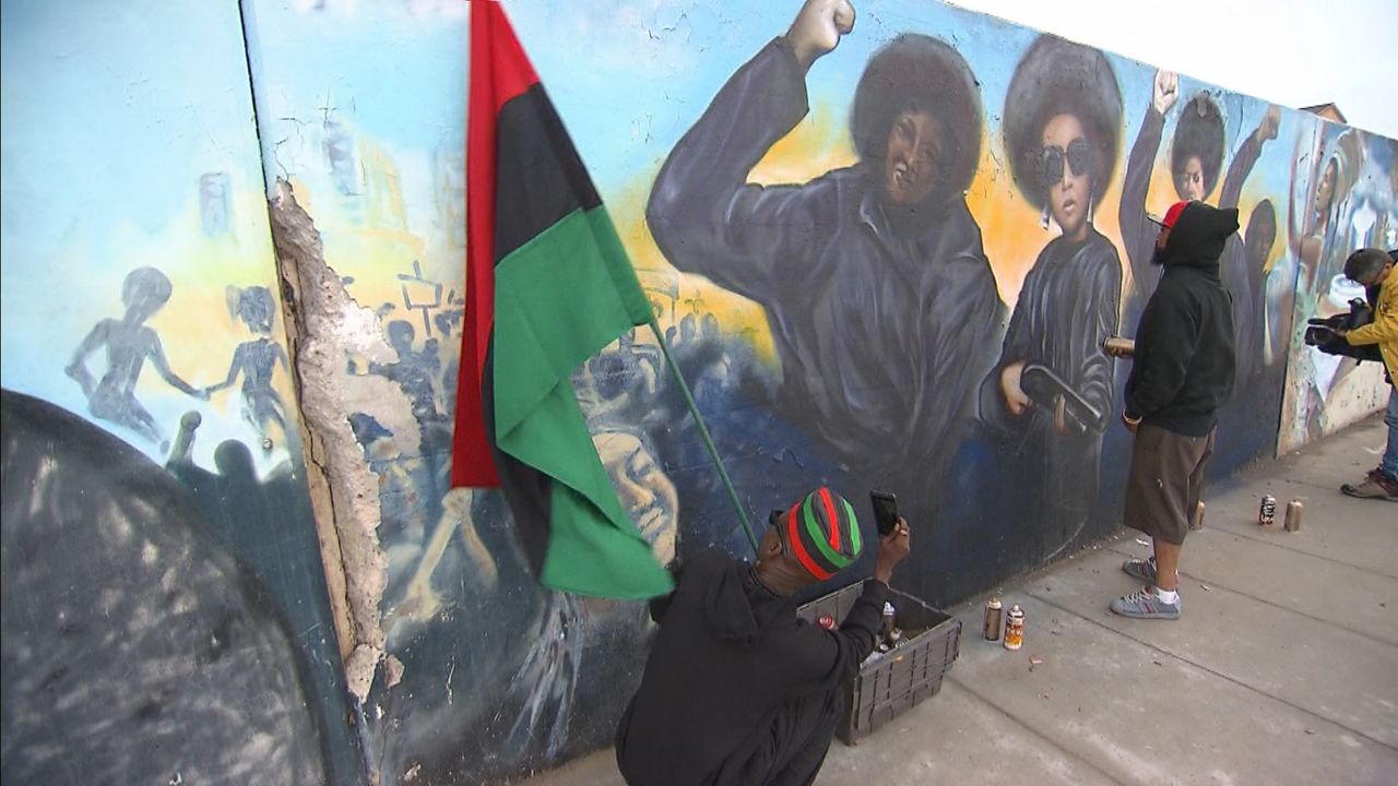 Artist Who Helped Create Mural Returns to Undo Vandalism