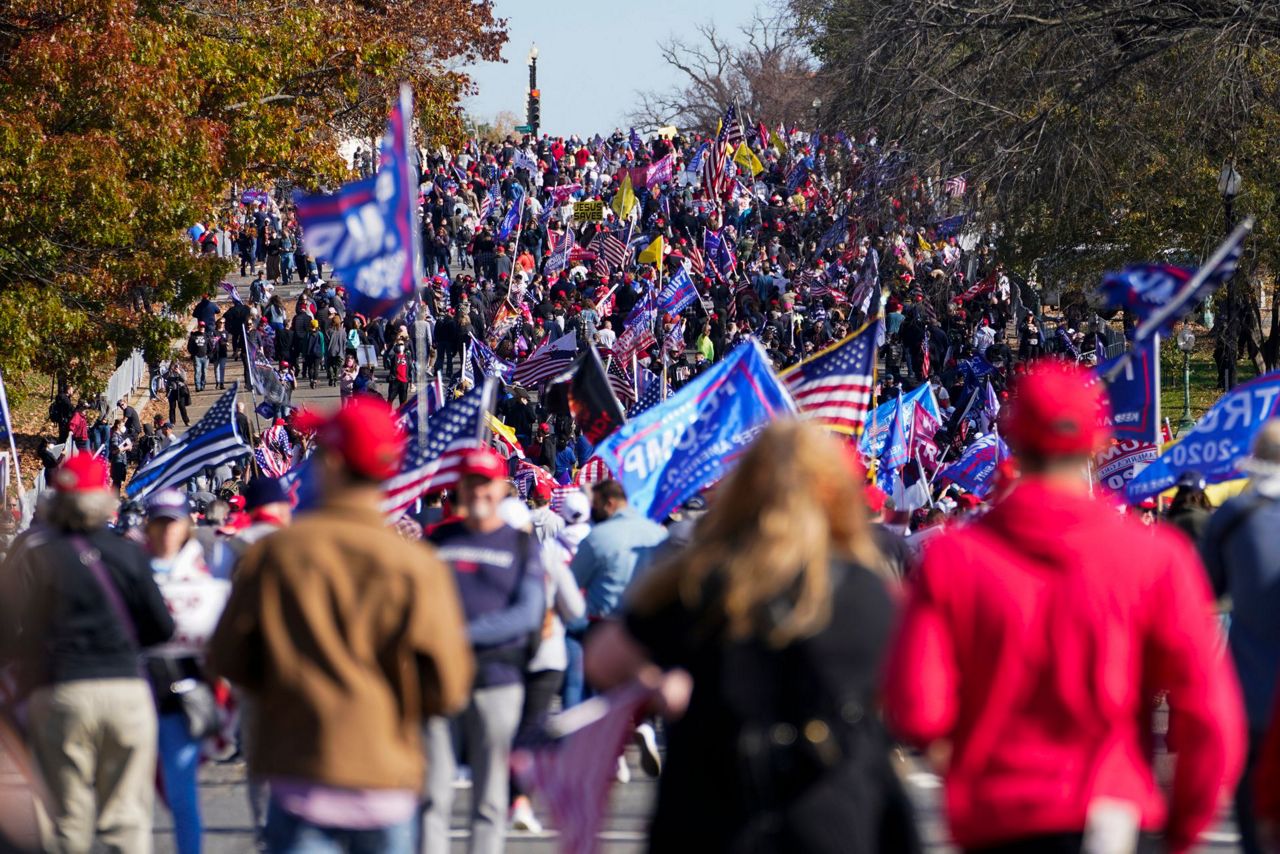 Trump thrills protesting supporters with motorcade drive-by
