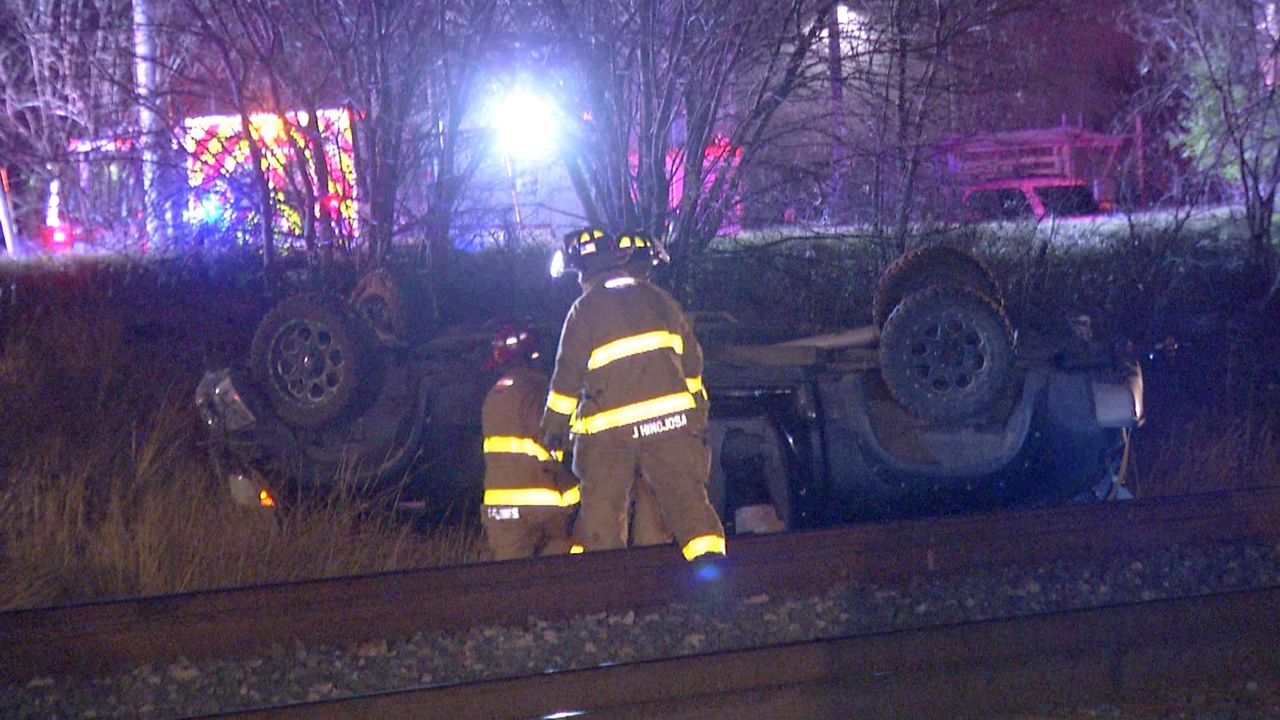 Driver Rescued After Car Flips Over Near Train Tracks