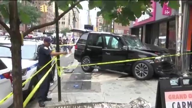 NYPD: 4 hurt when car jumps curb, slams into building