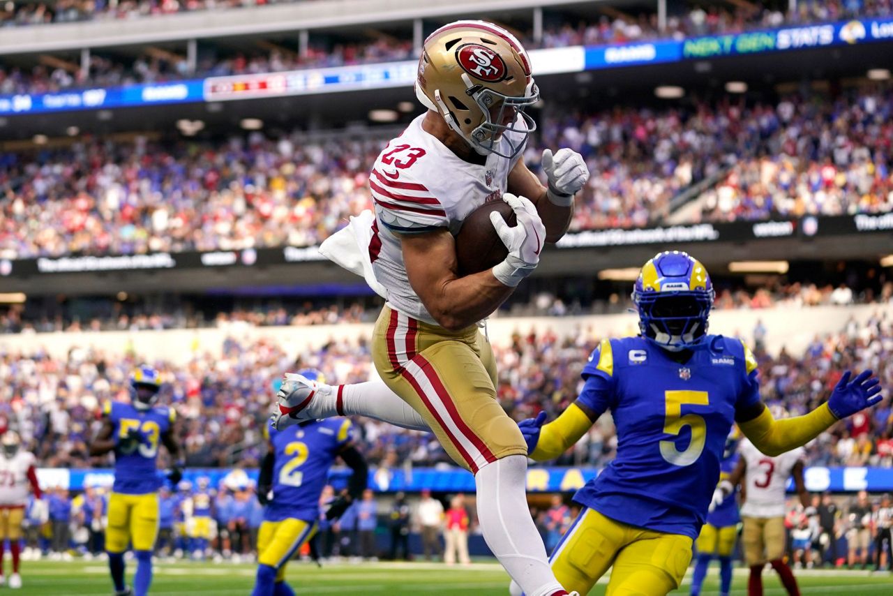 McCaffrey throws, catches, rushes for TDs, Niners rout Rams