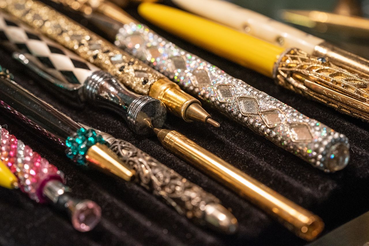 Couple making their mark with writing instruments