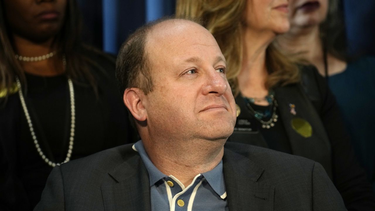 Colorado governor signs gun control bills after massacre