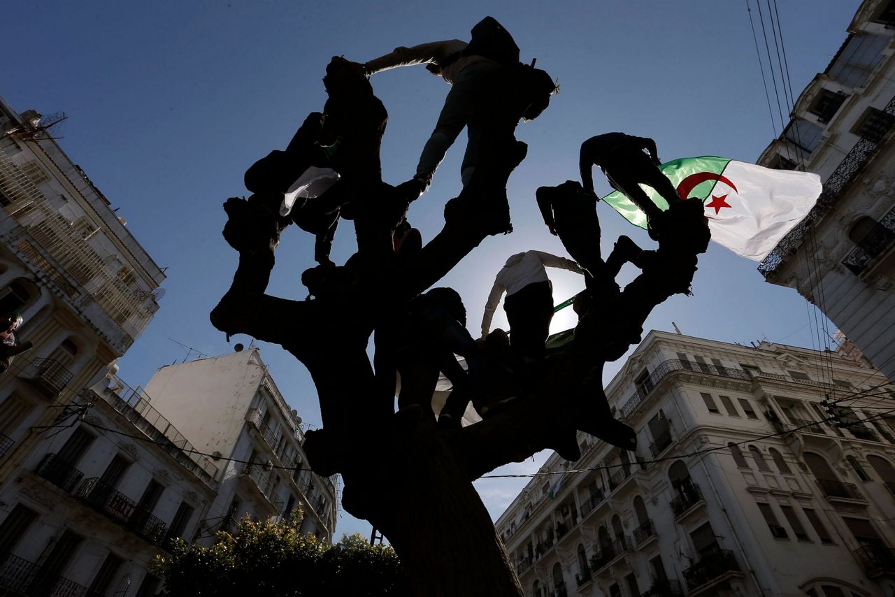 The Latest: Algerian police fire water cannon at protesters