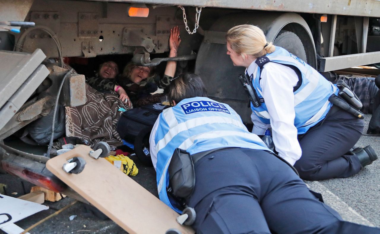 UK climate protesters block roads, glue themselves to train