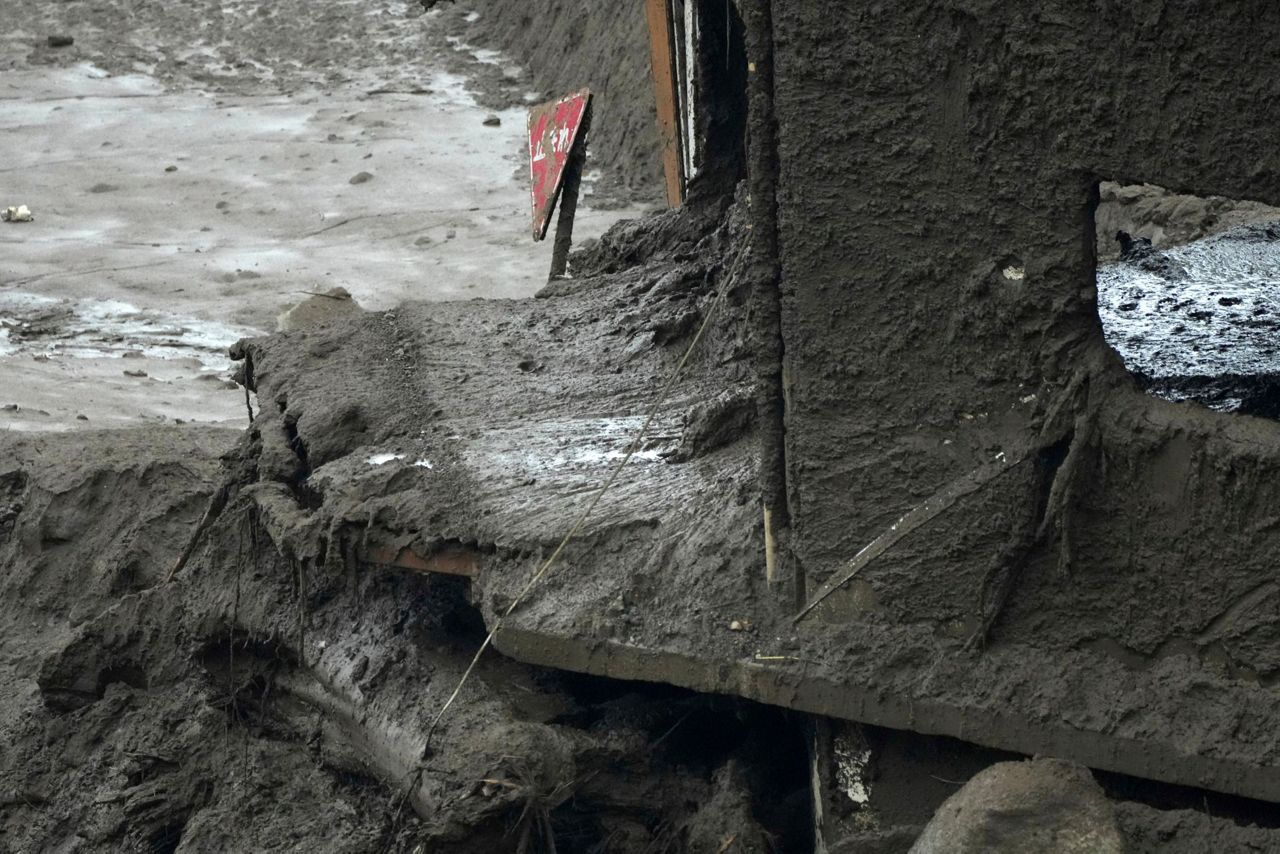 Rescuers slog through mud in Japan resort where 20 missing