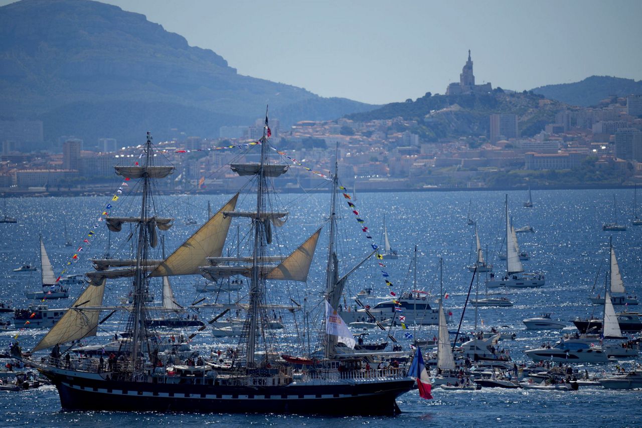 A ship carrying the Olympic torch arrives in Marseille amid fanfare and ...