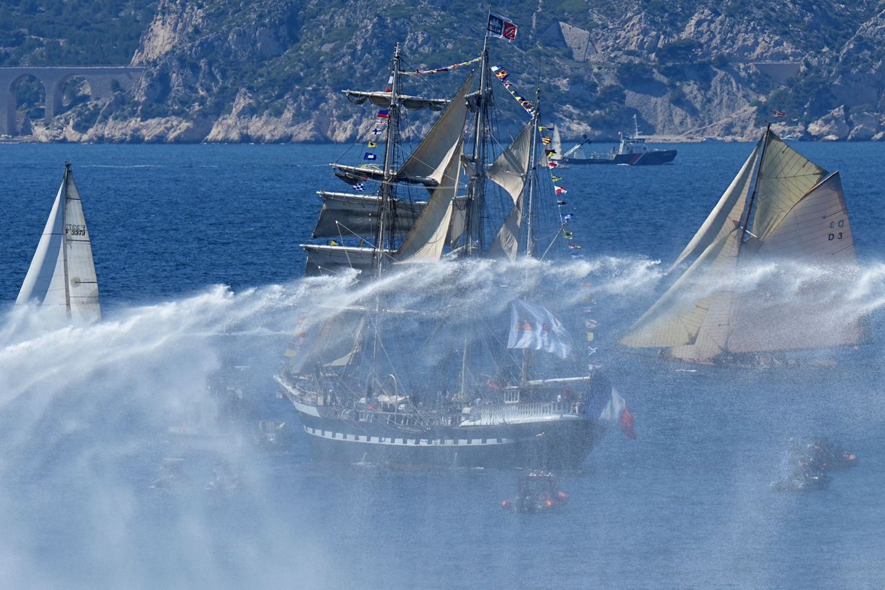 A ship carrying the Olympic torch arrives in Marseille amid fanfare and ...