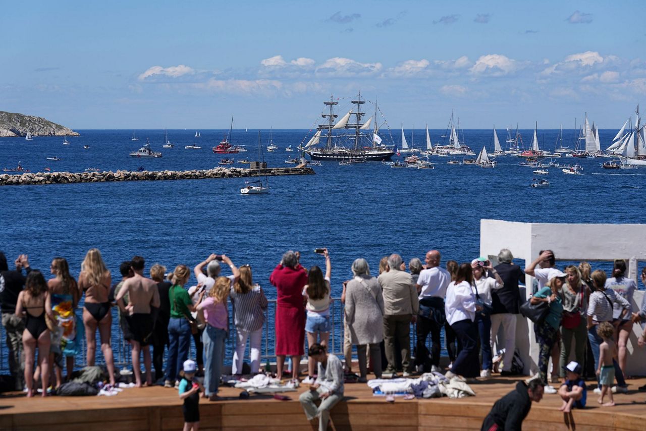 A ship carrying the Olympic torch arrives in Marseille amid fanfare and ...