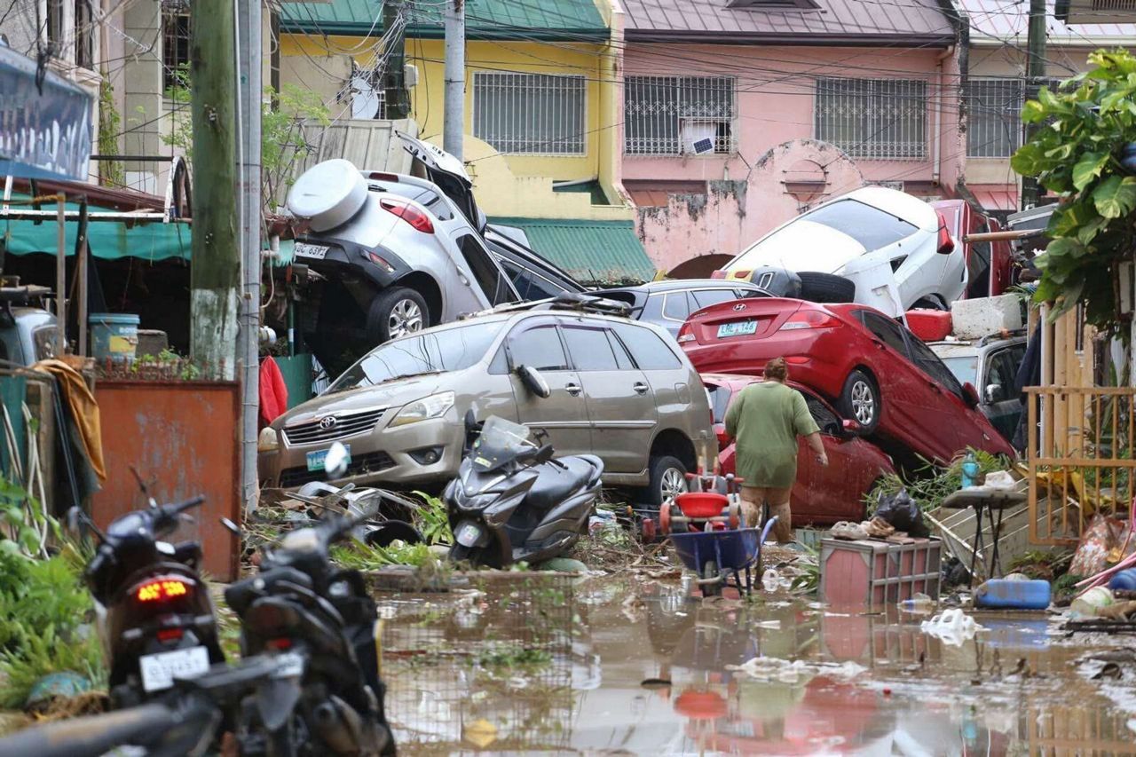Typhoon leaves at least 2 dead, traps people on roofs and submerges ...