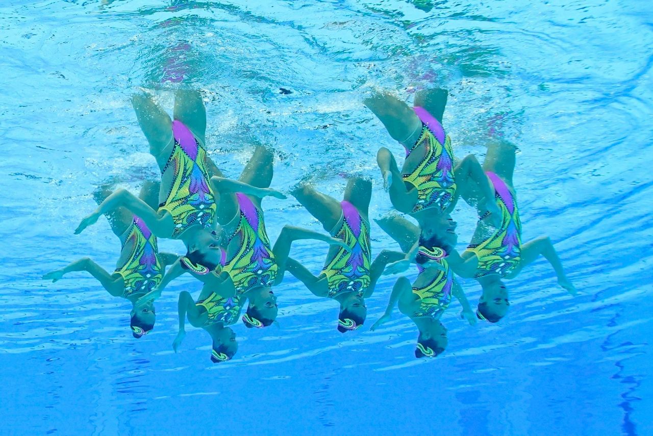 EXPLAINER: Olympic photos from far above — and underwater