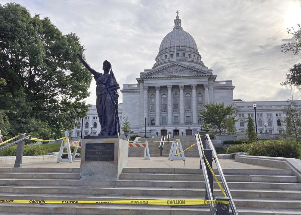 Workers reinstall Wisconsin statues downed in 2020 protest