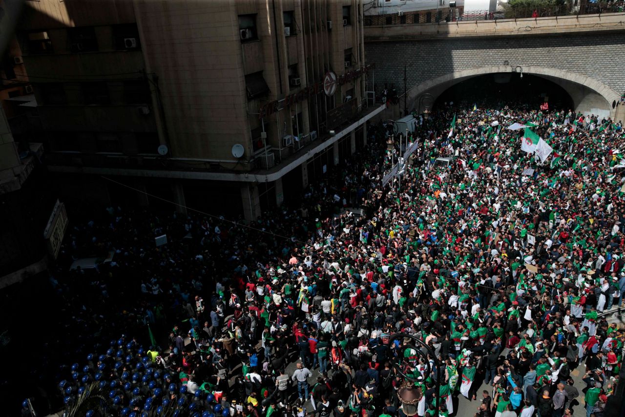 The Latest: Algerian police fire water cannon at protesters