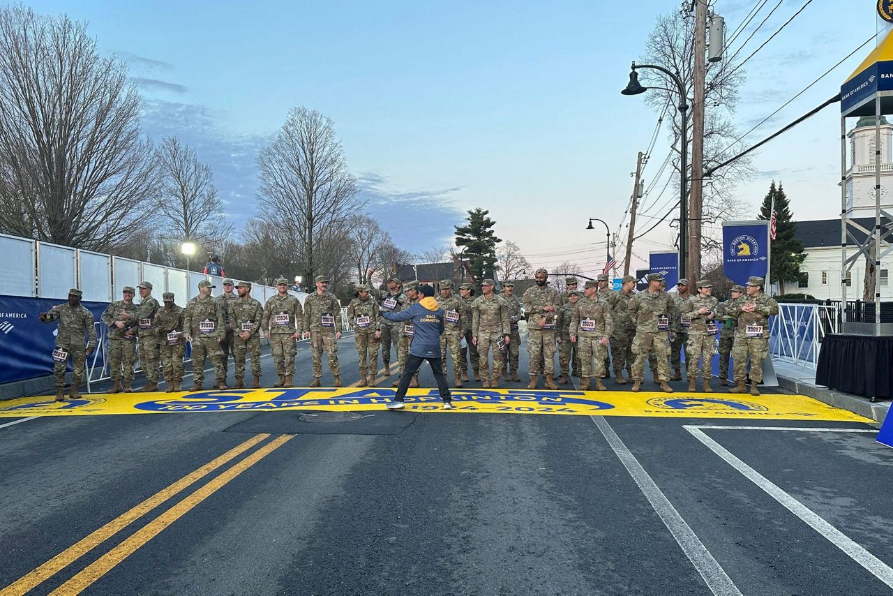 Military marchers set out from Hopkinton to start the 128th Boston Marathon