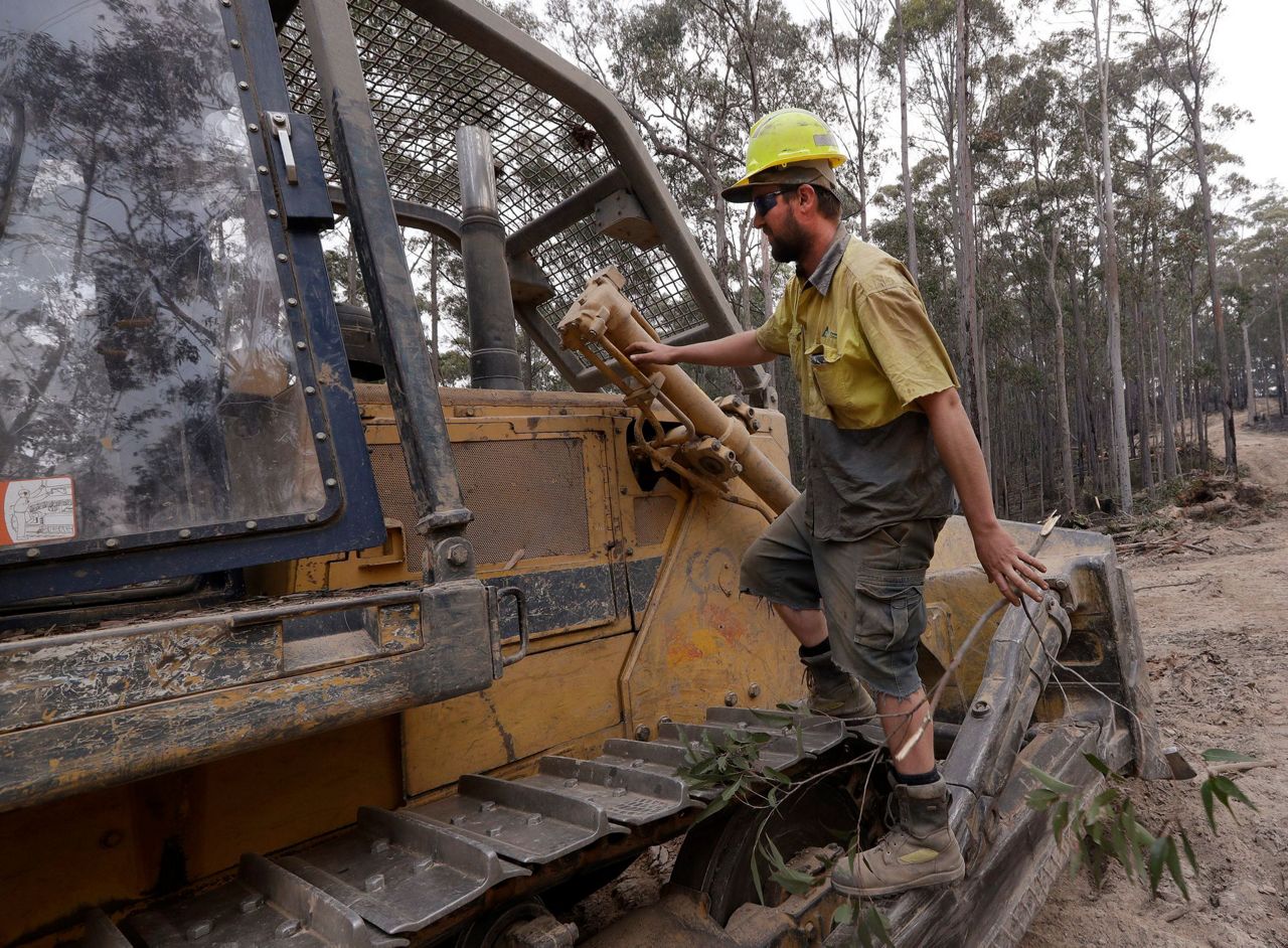 Firefighter dies as Australia plans to adapt to wildfires