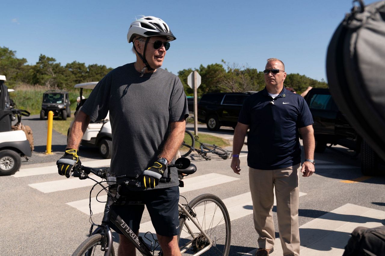 Biden takes spill while getting off bike after beach ride