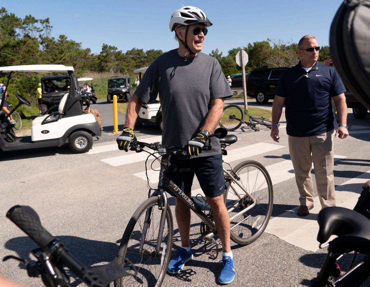 Biden takes spill while getting off bike after beach ride