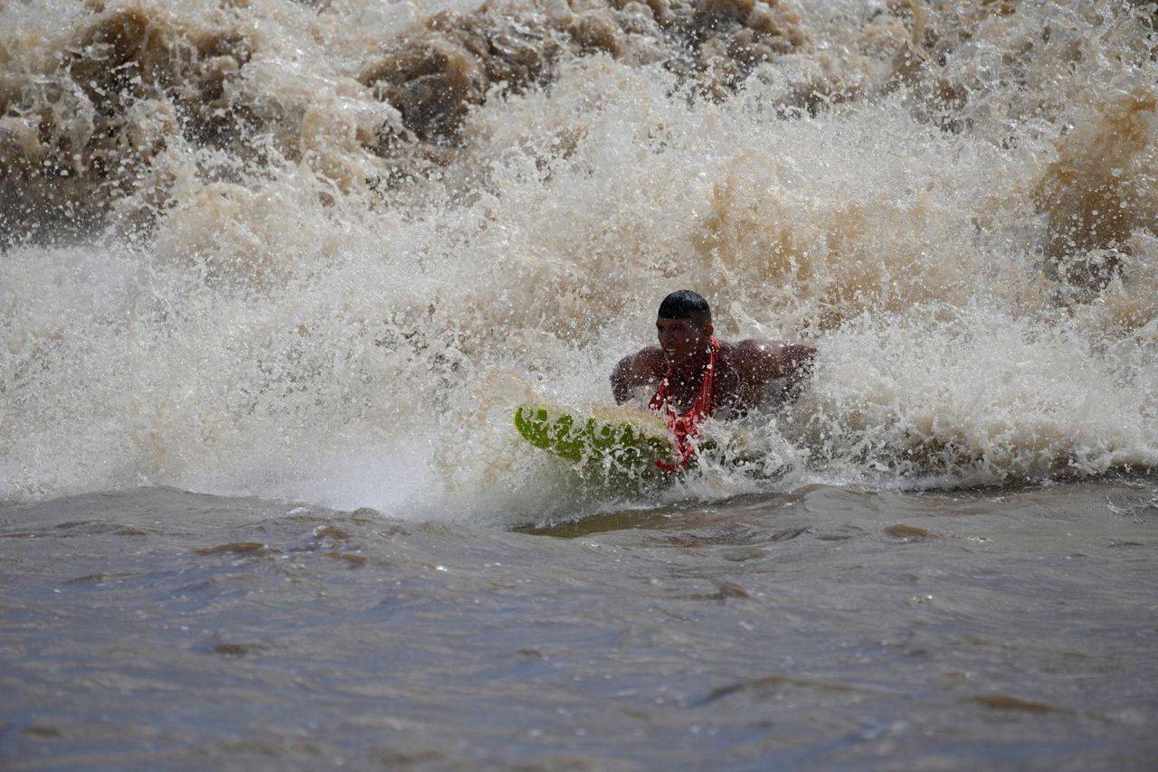 Surfers at Amazon's mouth ride some of world's longest-lasting waves