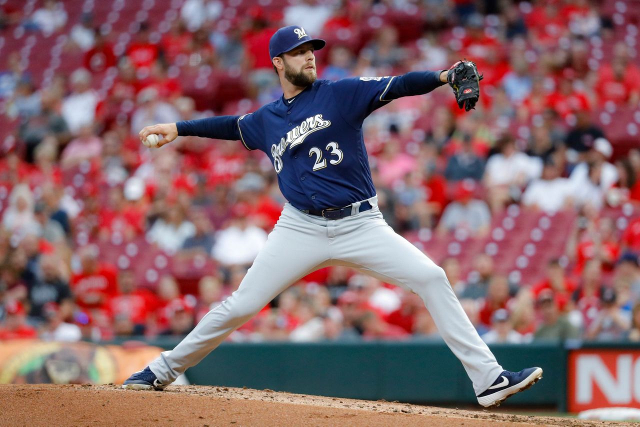 Surging Brewers clinch playoff berth with 9-2 win over Reds