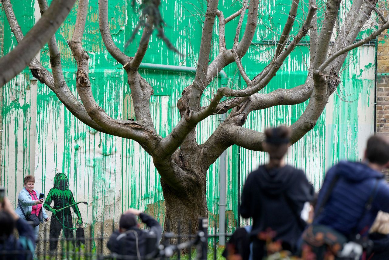 A new Banksy mural sprouts beside a cropped tree in London. Many see an ...