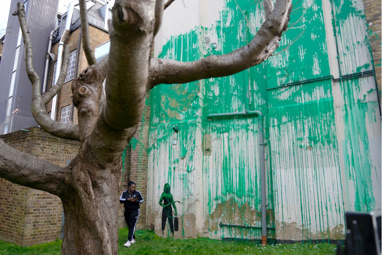 A new Banksy mural sprouts beside a cropped tree in London. Many see an ...