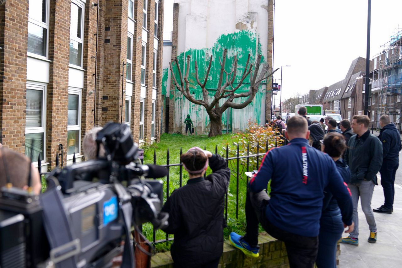 A new Banksy mural sprouts beside a cropped tree in London. Many see an ...