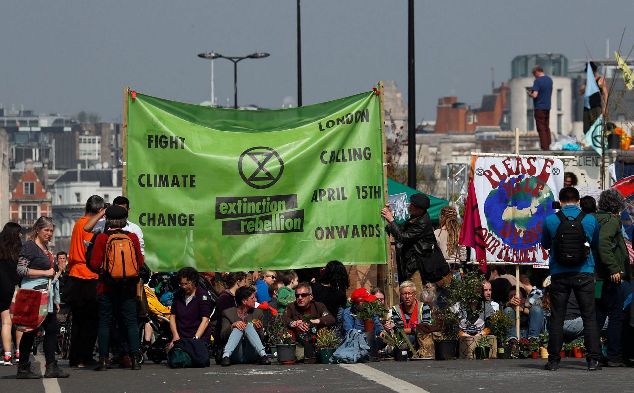 UK climate protesters block roads, glue themselves to train