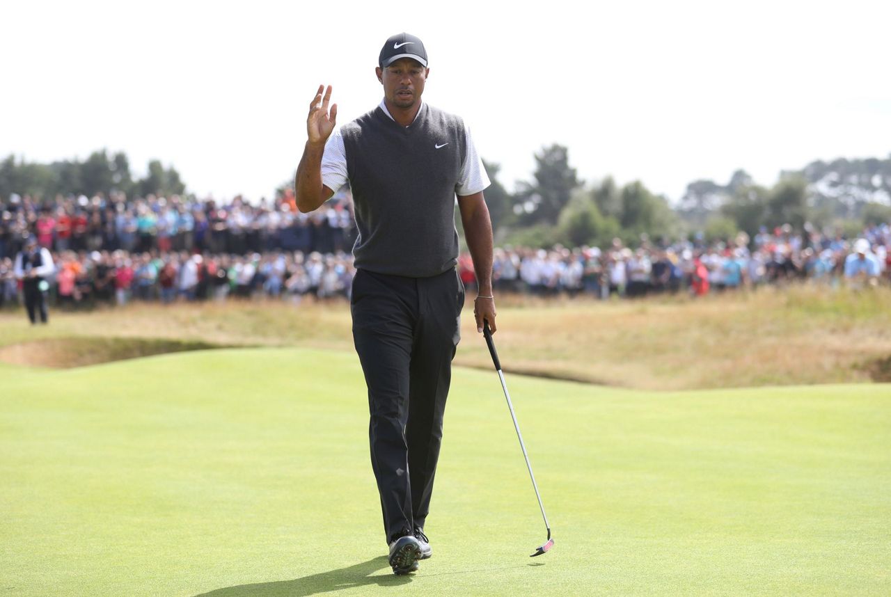 The Latest: No wind, good scoring early in British Open