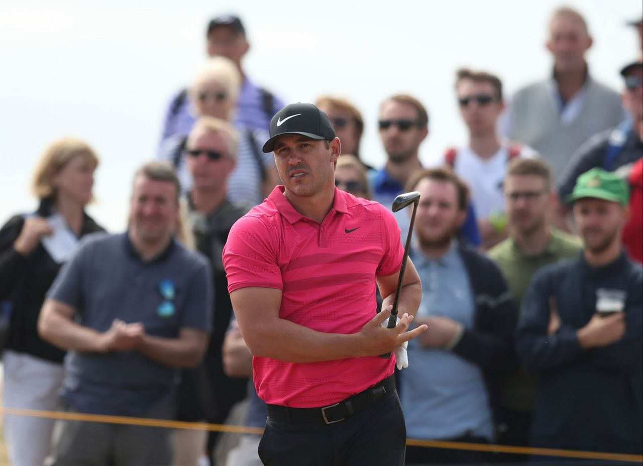 The Latest: No wind, good scoring early in British Open