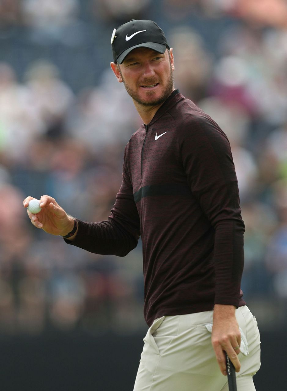 The Latest: No wind, good scoring early in British Open