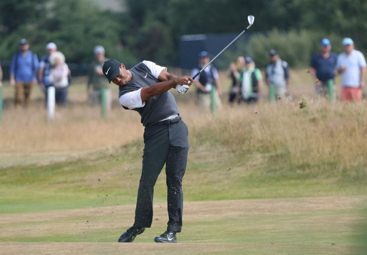 The Latest: No wind, good scoring early in British Open
