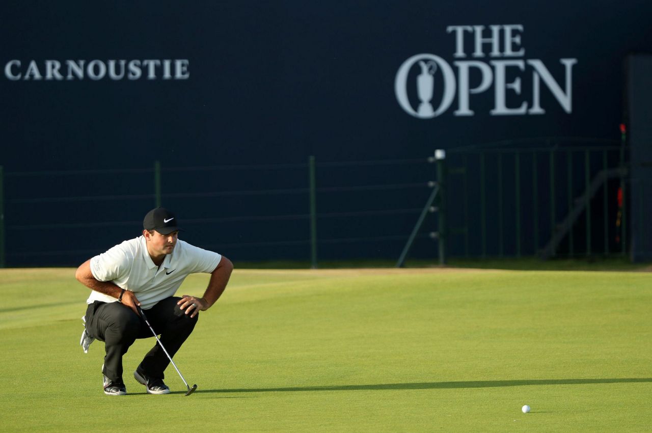 The Latest: No wind, good scoring early in British Open