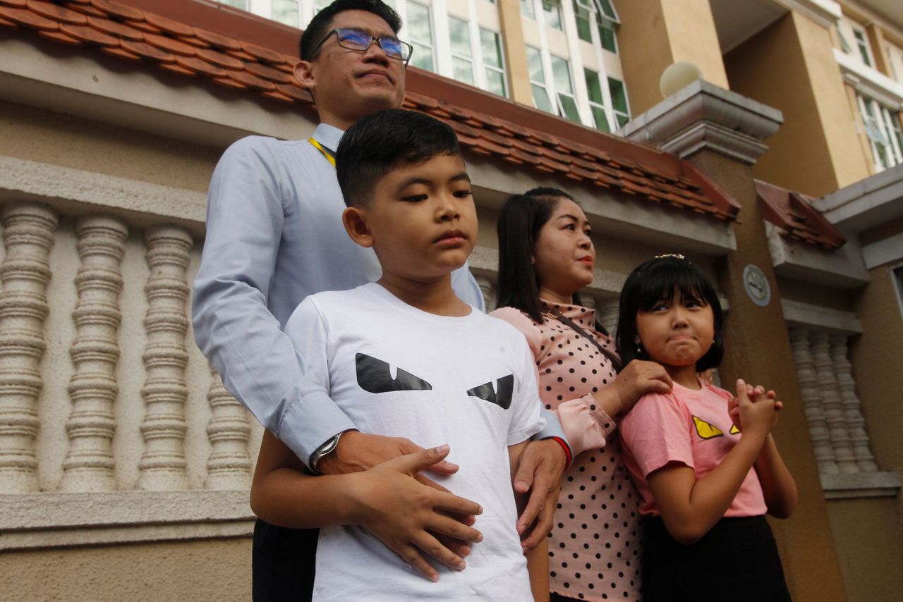 Cambodian judge orders new probe in reporters’ spying case