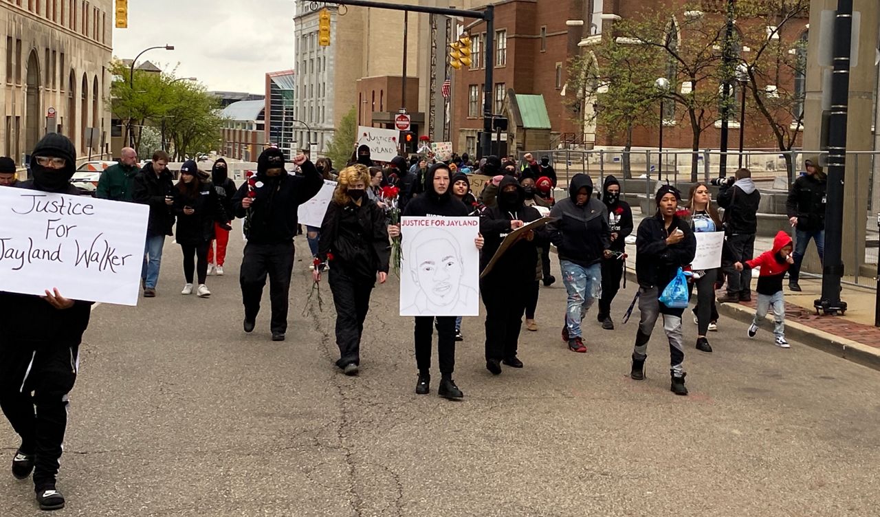 Protesters leave carnations at Akron Police headquarters
