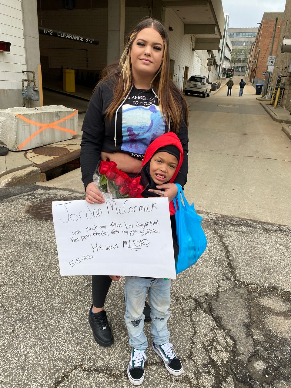 Protesters leave carnations at Akron Police headquarters