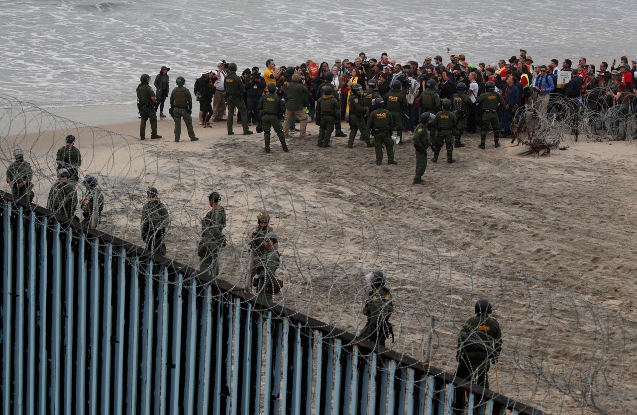 Border Patrol handcuffs demonstrators supporting migrants
