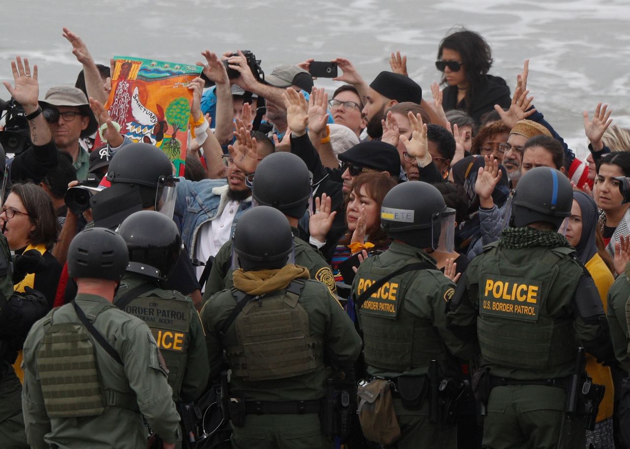 Border Patrol handcuffs demonstrators supporting migrants