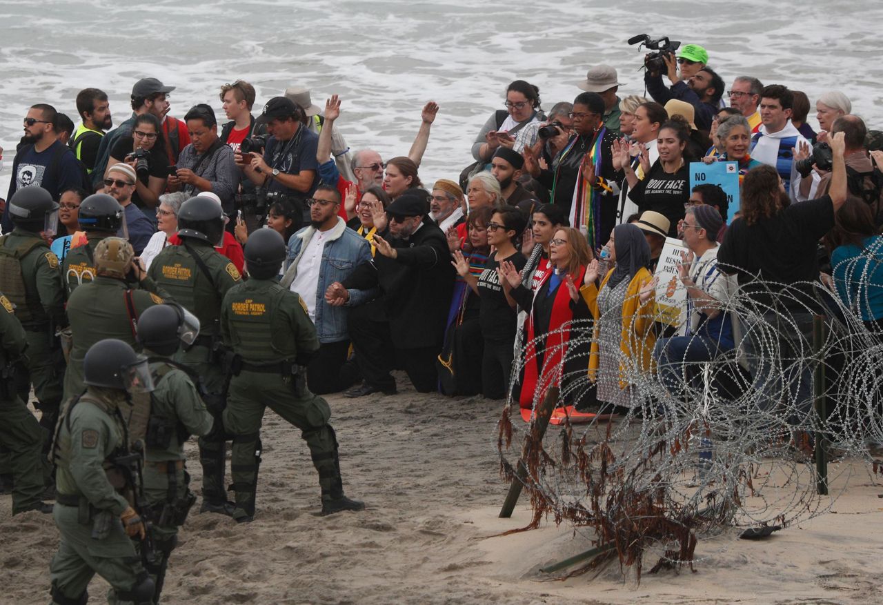 Border Patrol handcuffs demonstrators supporting migrants