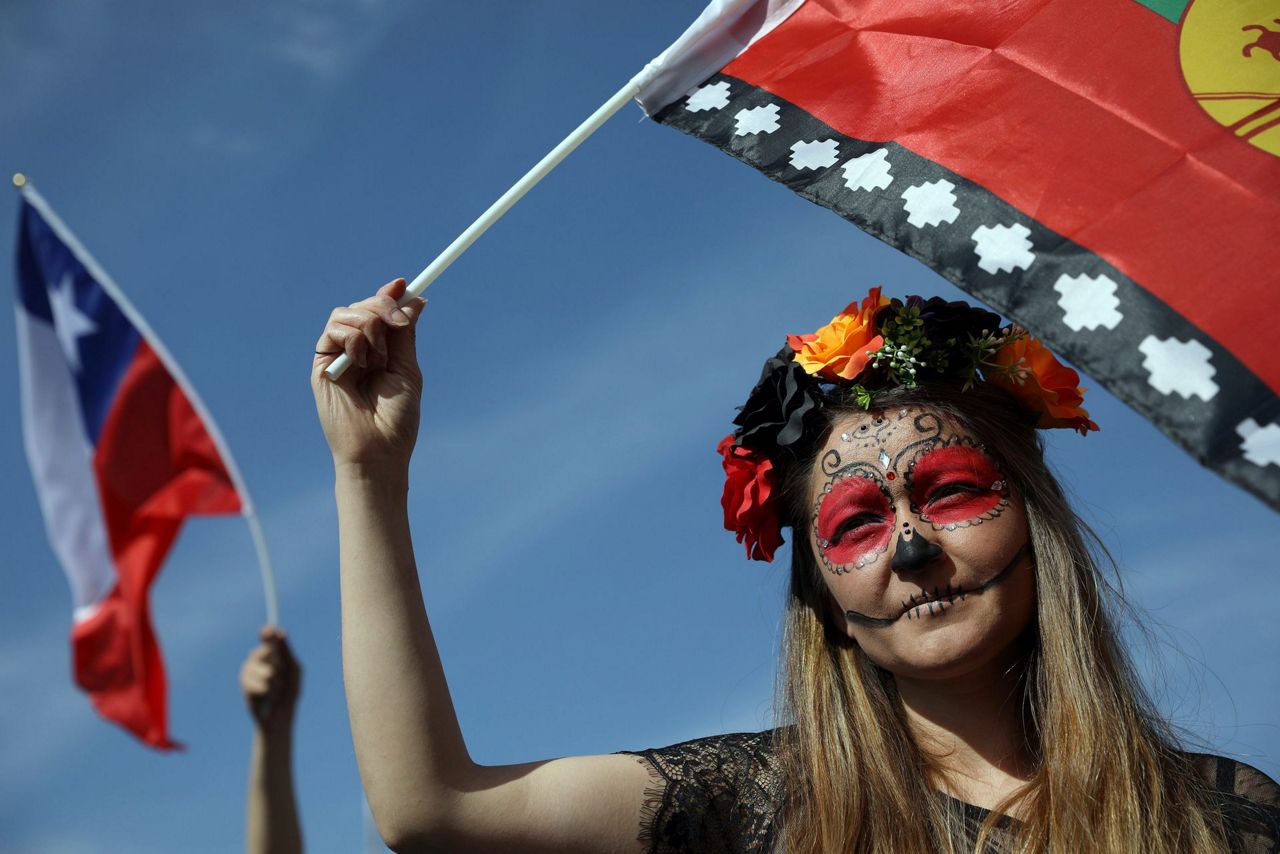 Thousands march in Chile protest after summit cancellations