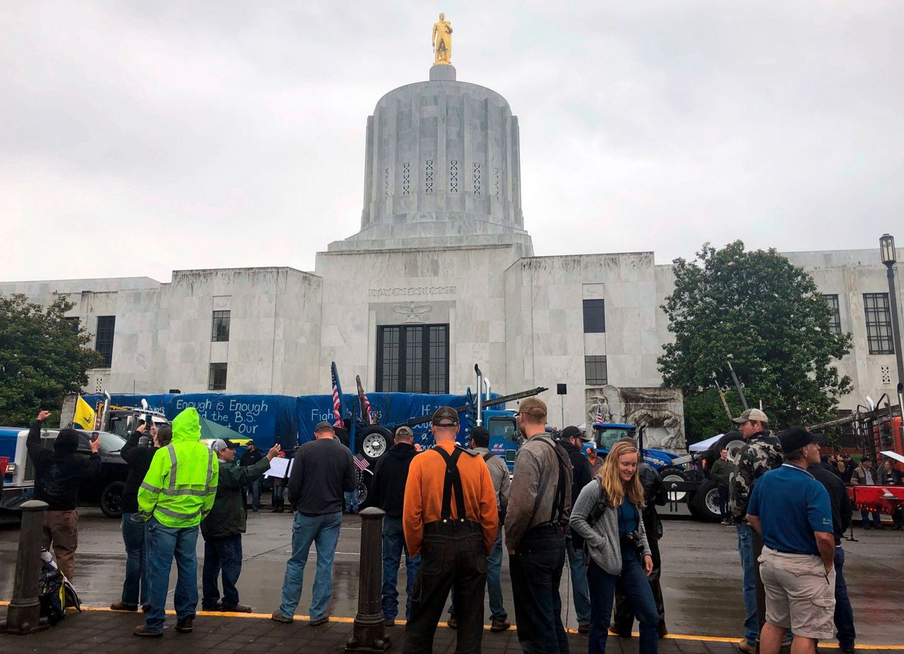 Truckers, loggers circle Oregon Capitol amid climate fight