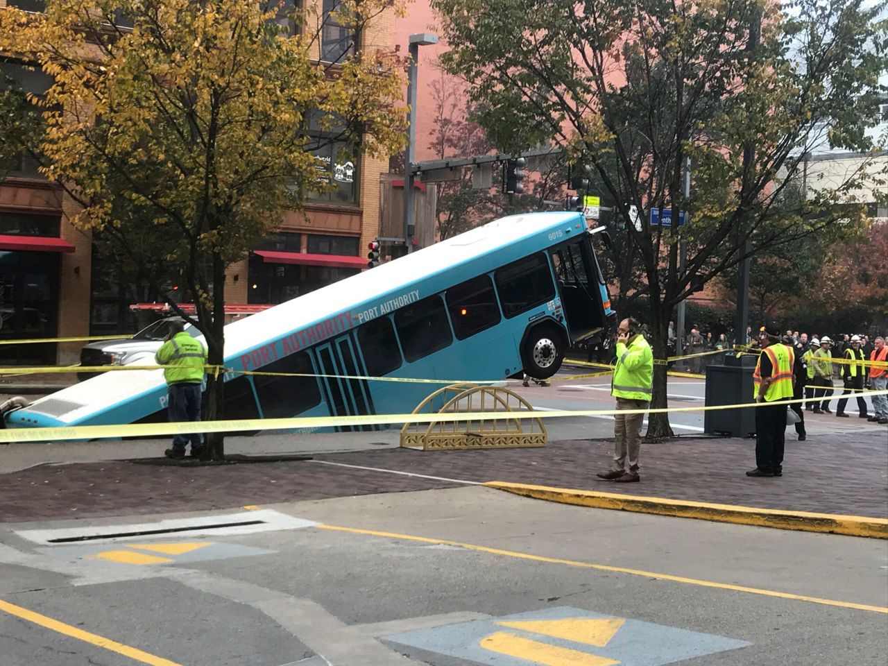 Sinkhole opens, swallows part of city bus during rush hour
