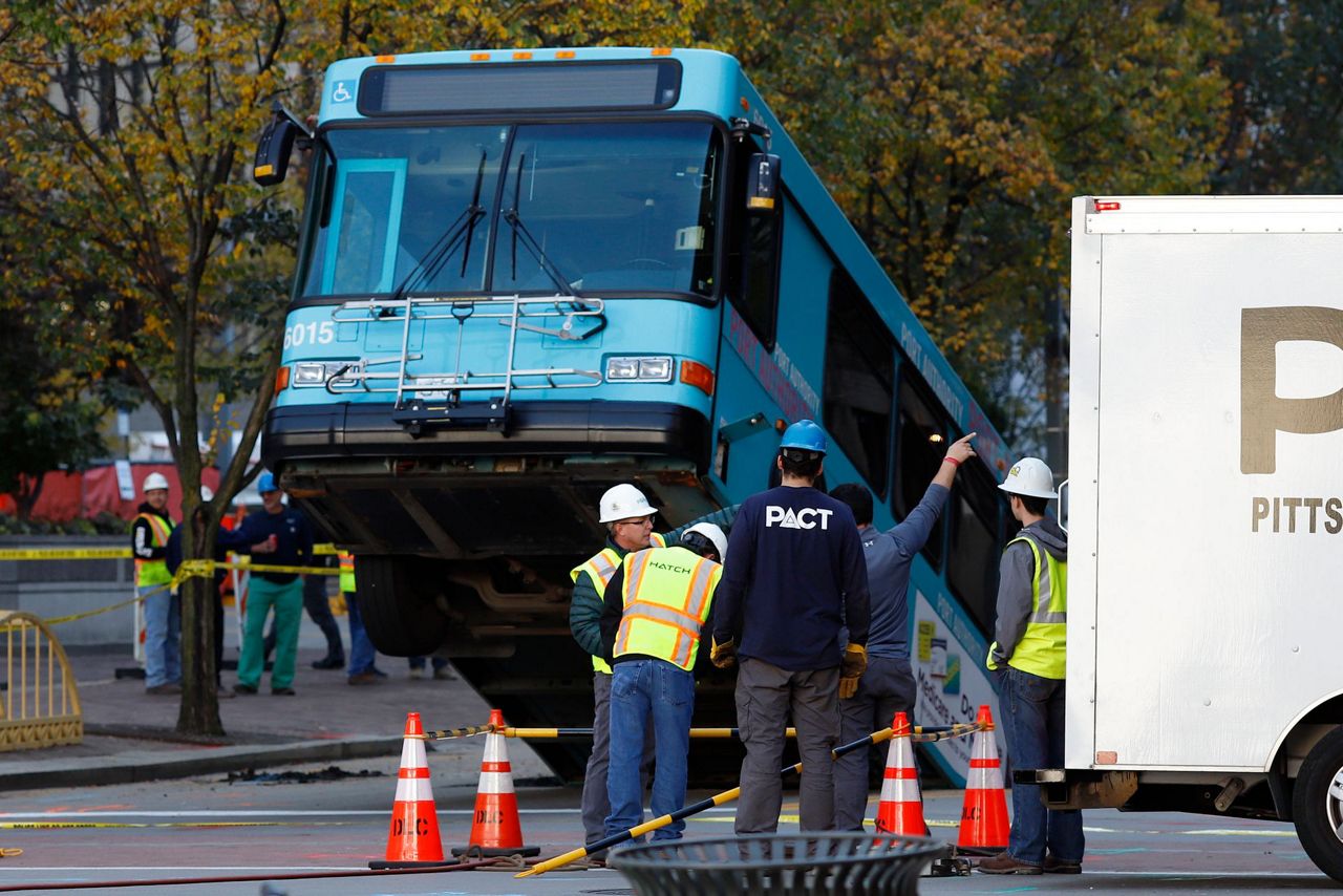 Sinkhole opens, swallows part of city bus during rush hour